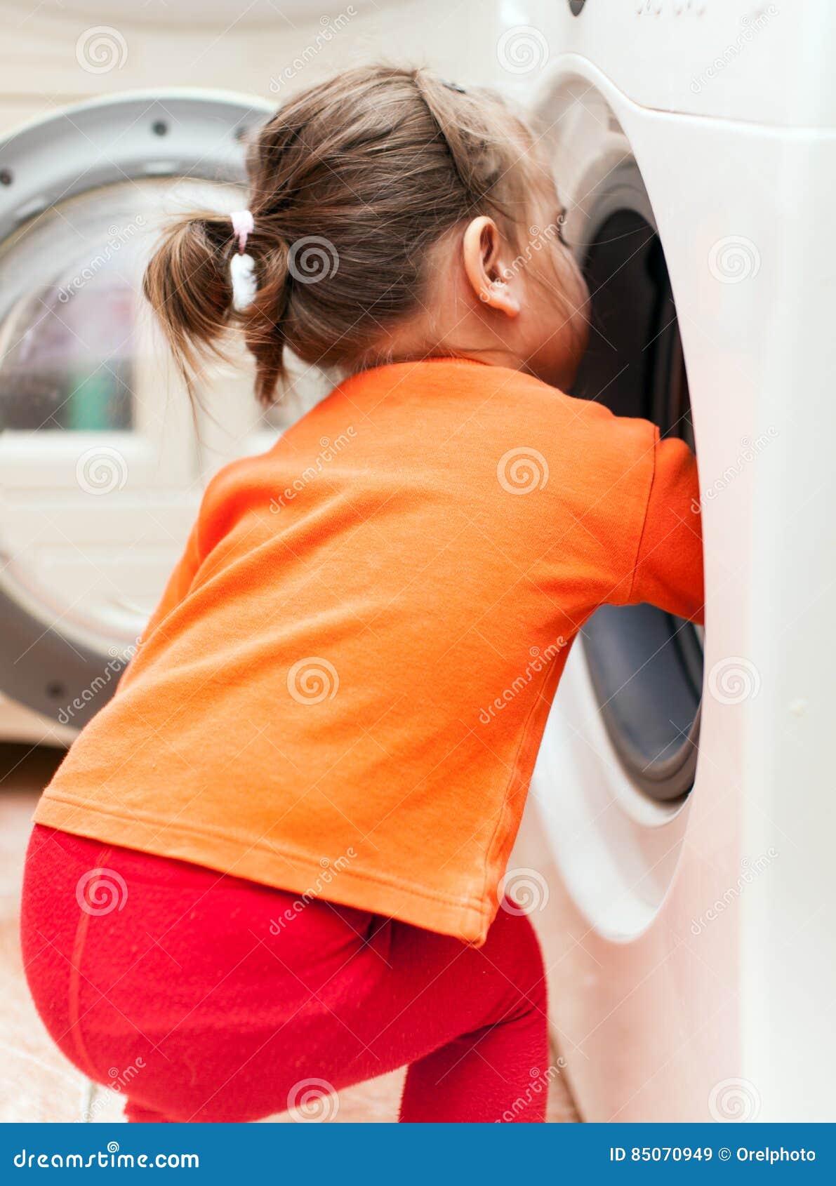 Girl is Looking into the Washing Machine Stock Image - Image of ...