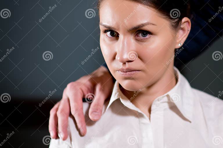 Girl Looks In Disgust While A Man Holds His Hand On Her Shoulder Stock