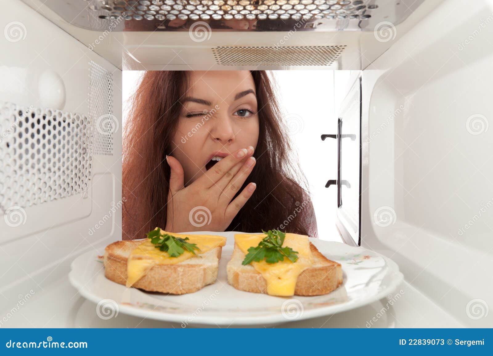 Girl looks in a microwave stock image. Image of microwave - 22839073