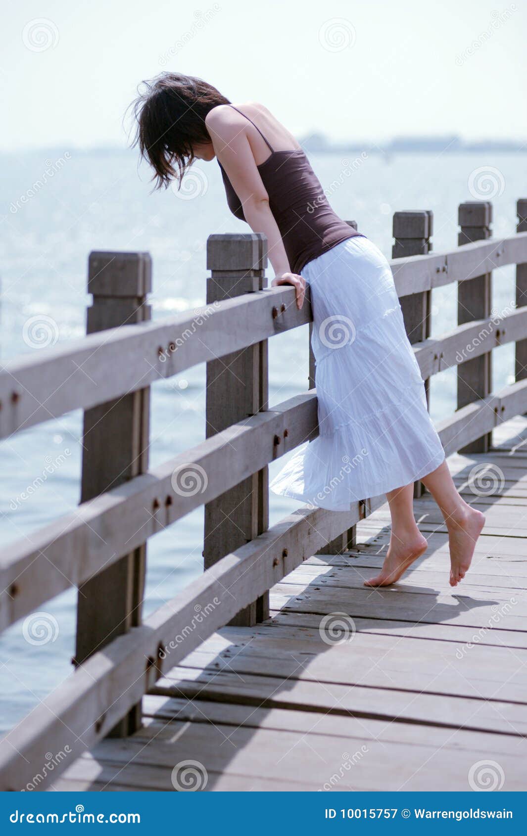 Girl looks over railing stock image. Image of relax, brunette - 10015757