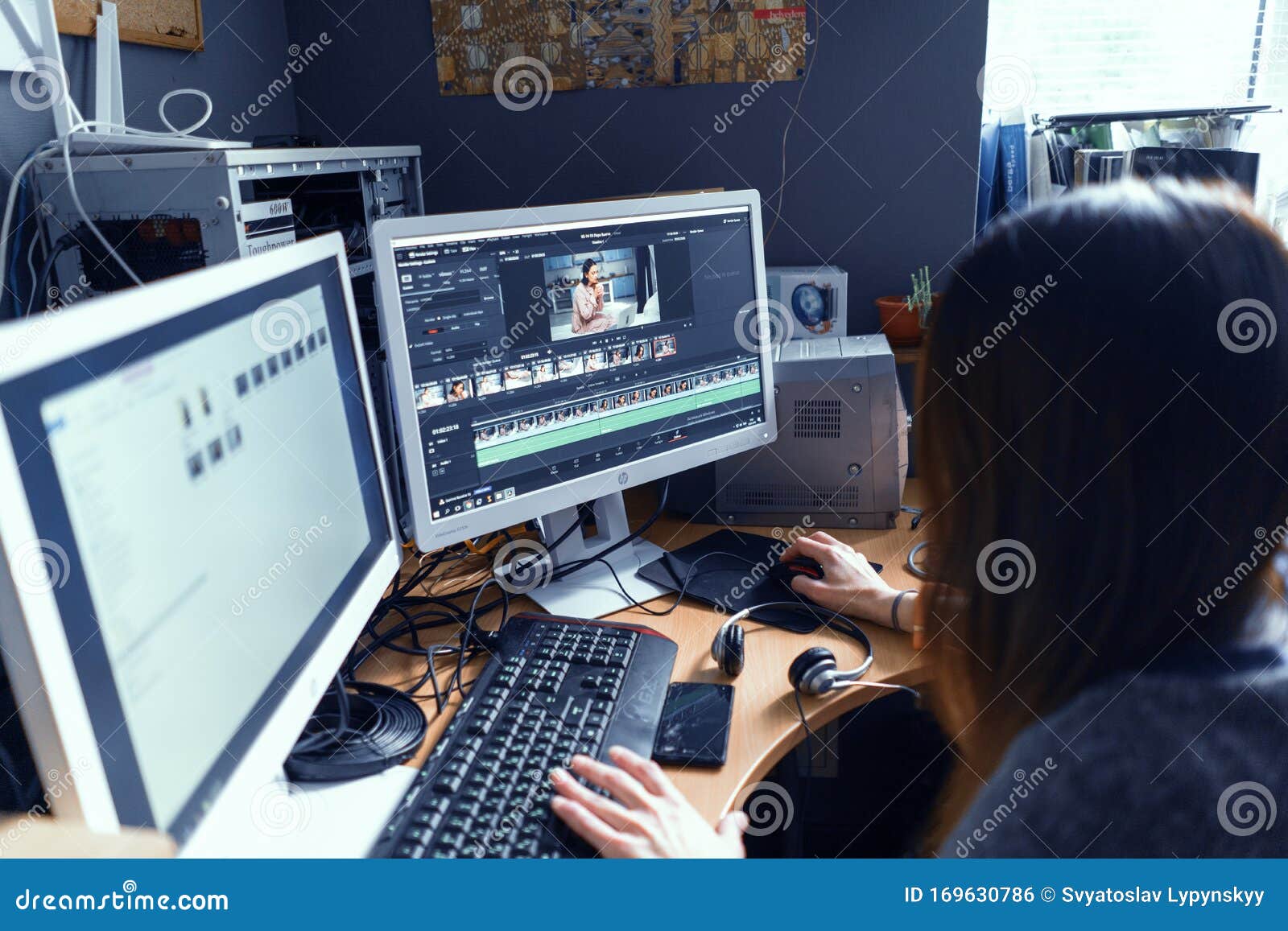 The Girl Looks at the Screens and Processes Video on a Computer with ...