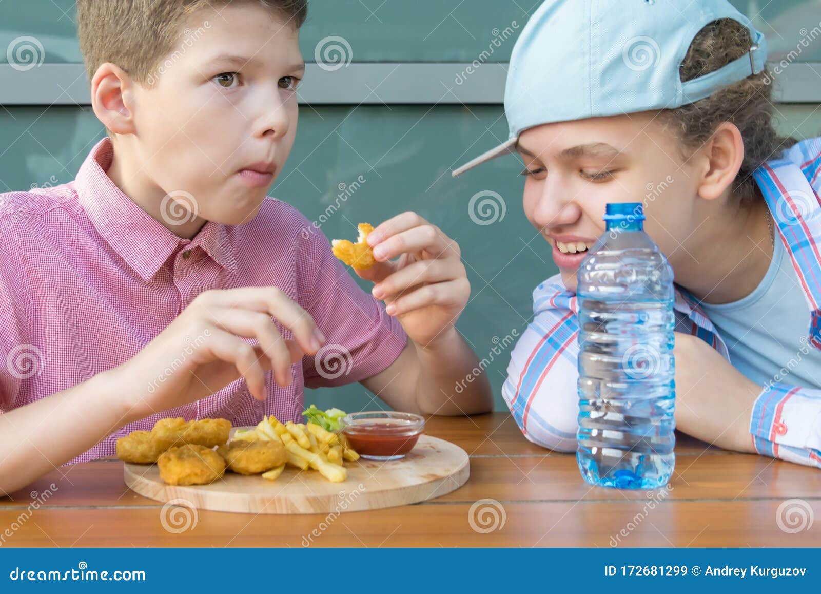 Girl Looks at What Boy Eats for Lunch, Front View Stock Image - Image ...