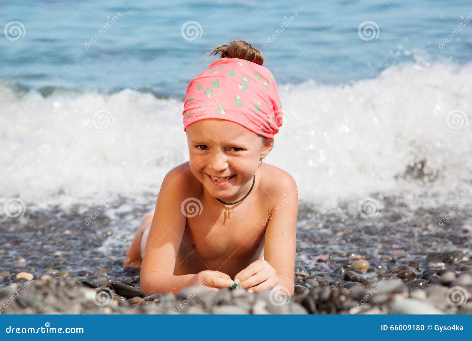 Girl lying on the beach stock photo. Image of child, enjoyment - 66009180