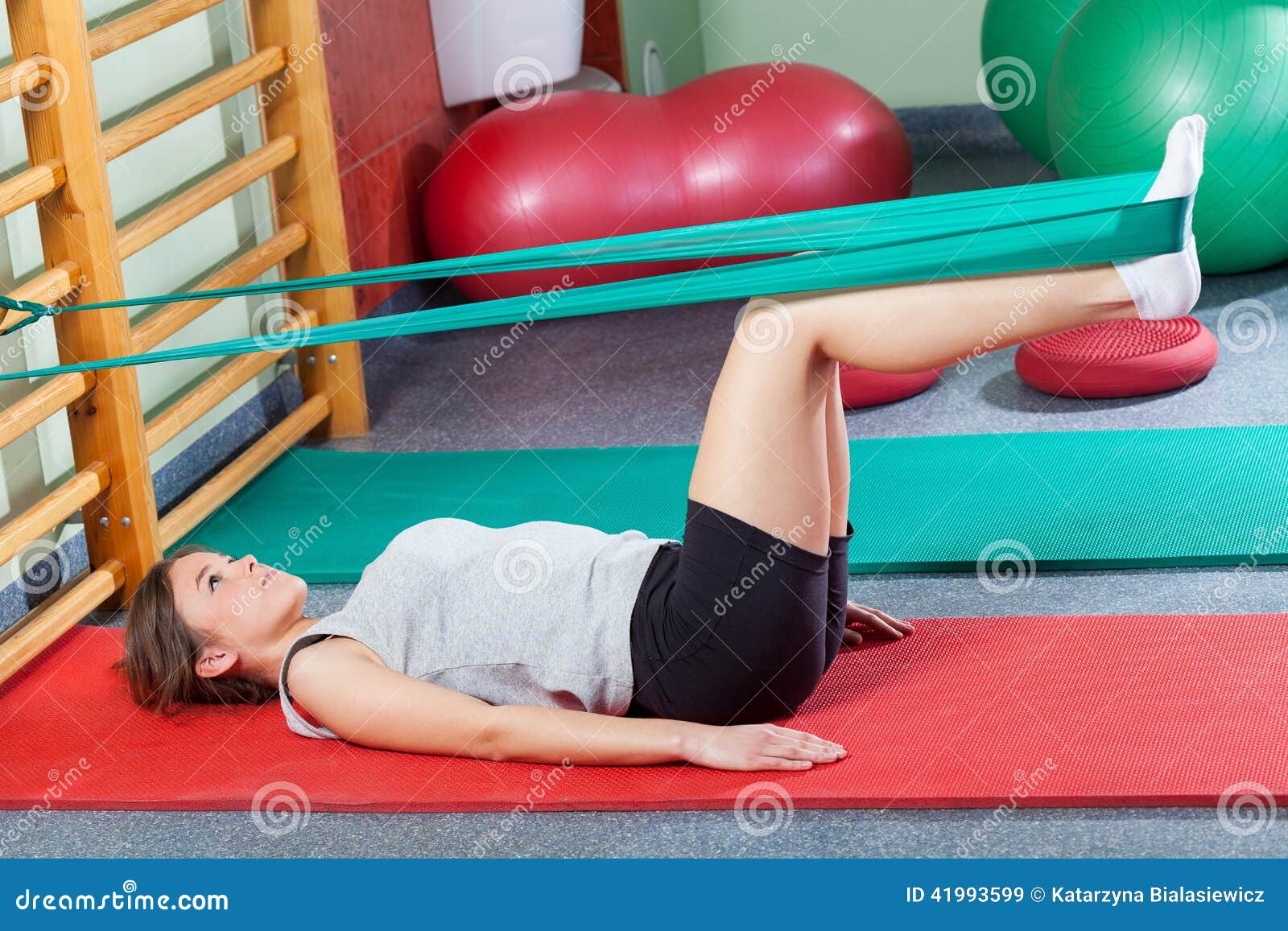 Girl Lying on Exercise Mat and Stretching Legs Stock Image - Image of ...