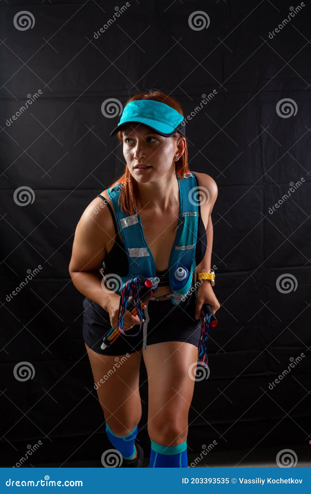 Girl Marathon Runner in Full Blue Uniform Runs in the Studio on a Black ...