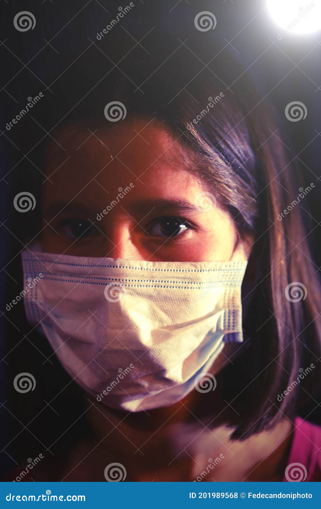 Girl with Mask and Light Behind Creating a Very Dramatic Effect Stock ...