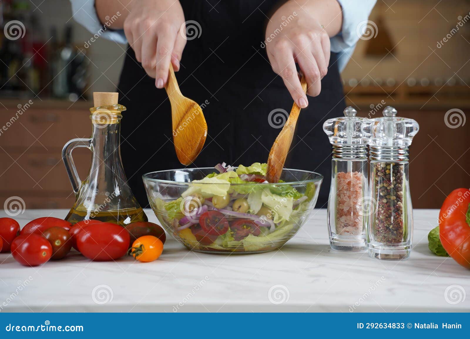 Girl Mixing Salad with Wooden Spoons. the Girl in the Process of Making ...