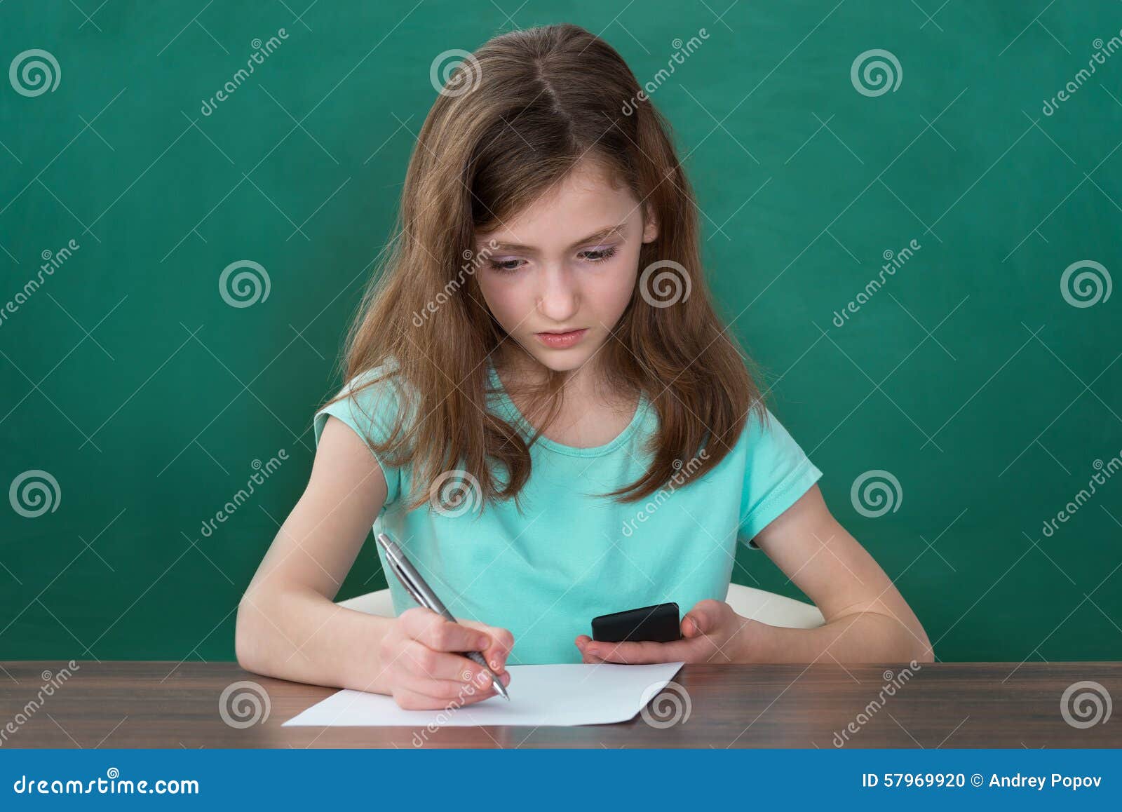 Girl with Mobile Phone Writing on Paper Stock Photo - Image of ...