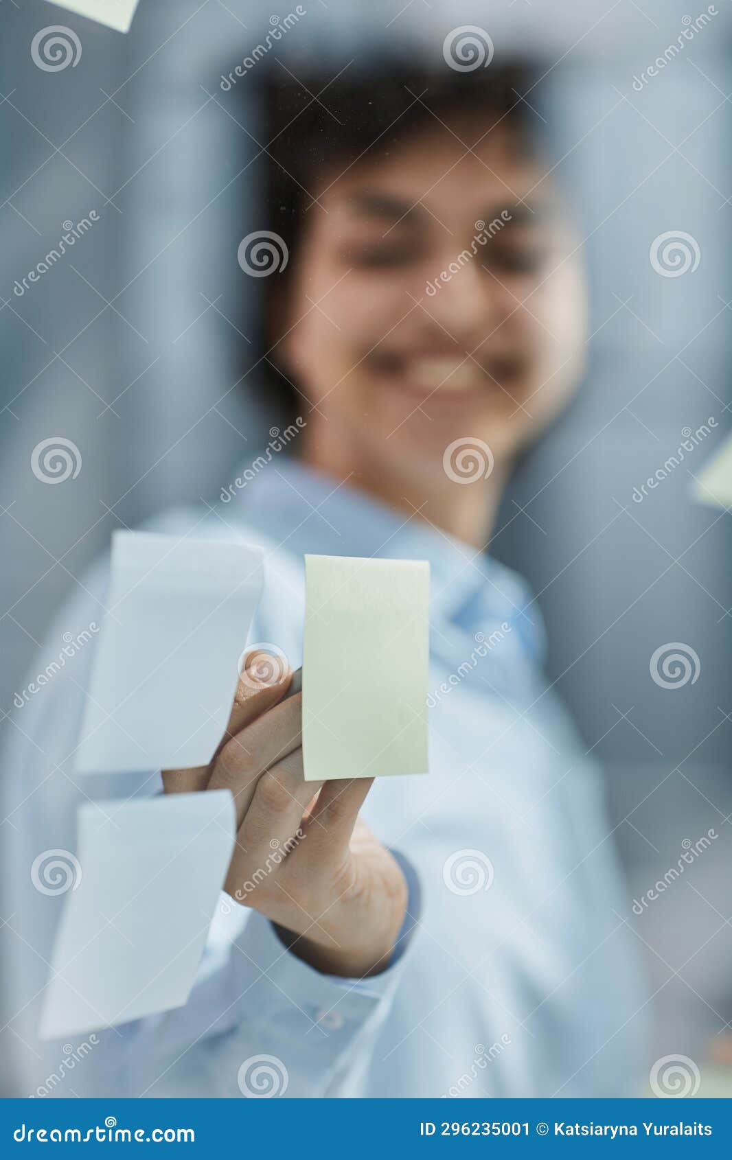 A Girl in a Modern Office Behind Glass Uses Sticky Notes and Makes ...