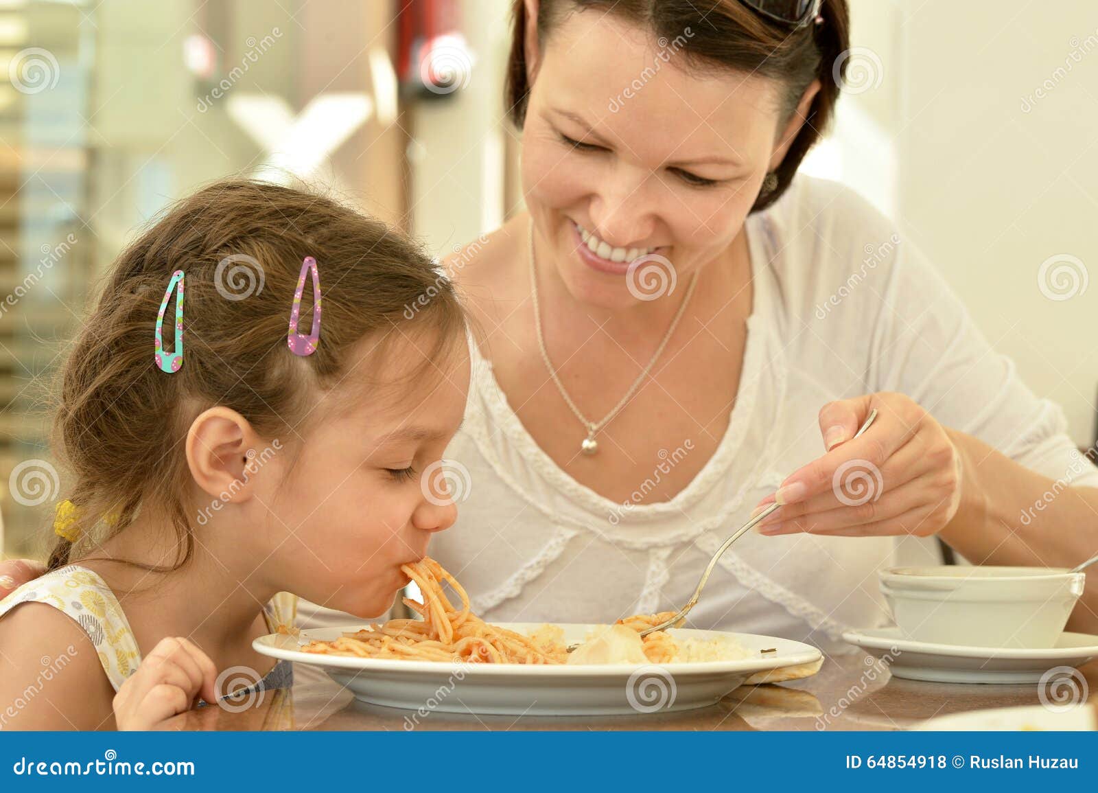 Girl with Mother Eating at Table Stock Photo - Image of meal, positive ...