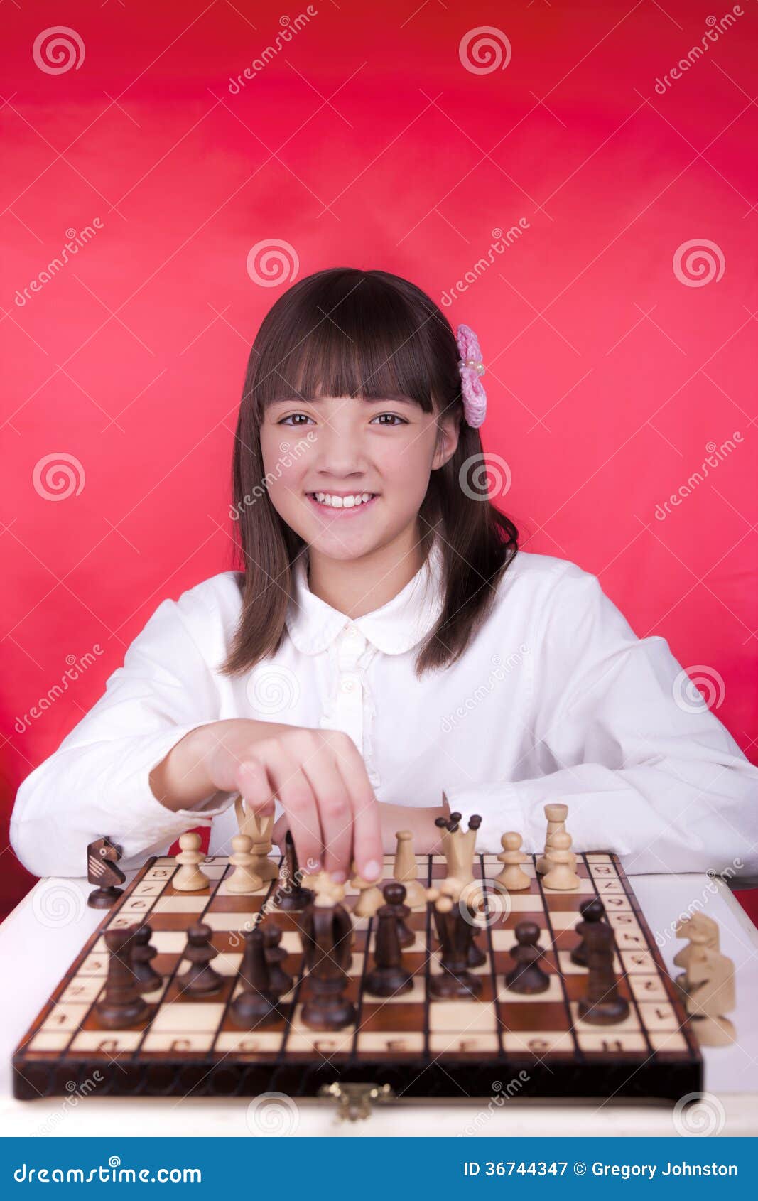 Girl moves chess piece. stock image. Image of chessboard - 36744347
