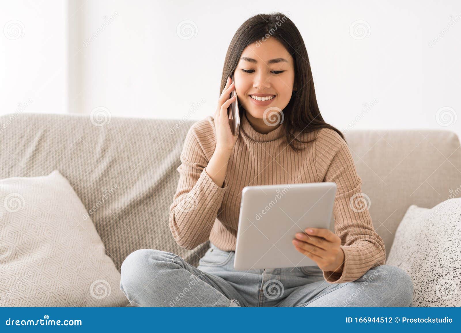 Girl Multitasking, Uing Tablet and Talking on Phone Stock Photo - Image ...
