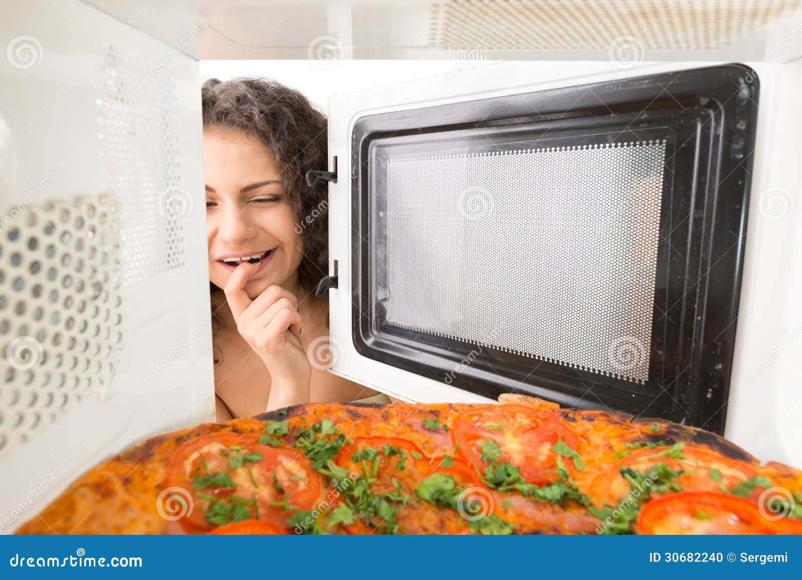 Girl open a microwave stock photo. Image of greens, beautiful - 30682240