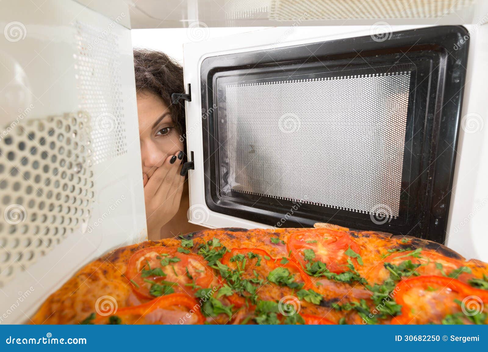 Girl open a microwave stock photo. Image of brunette - 30682250