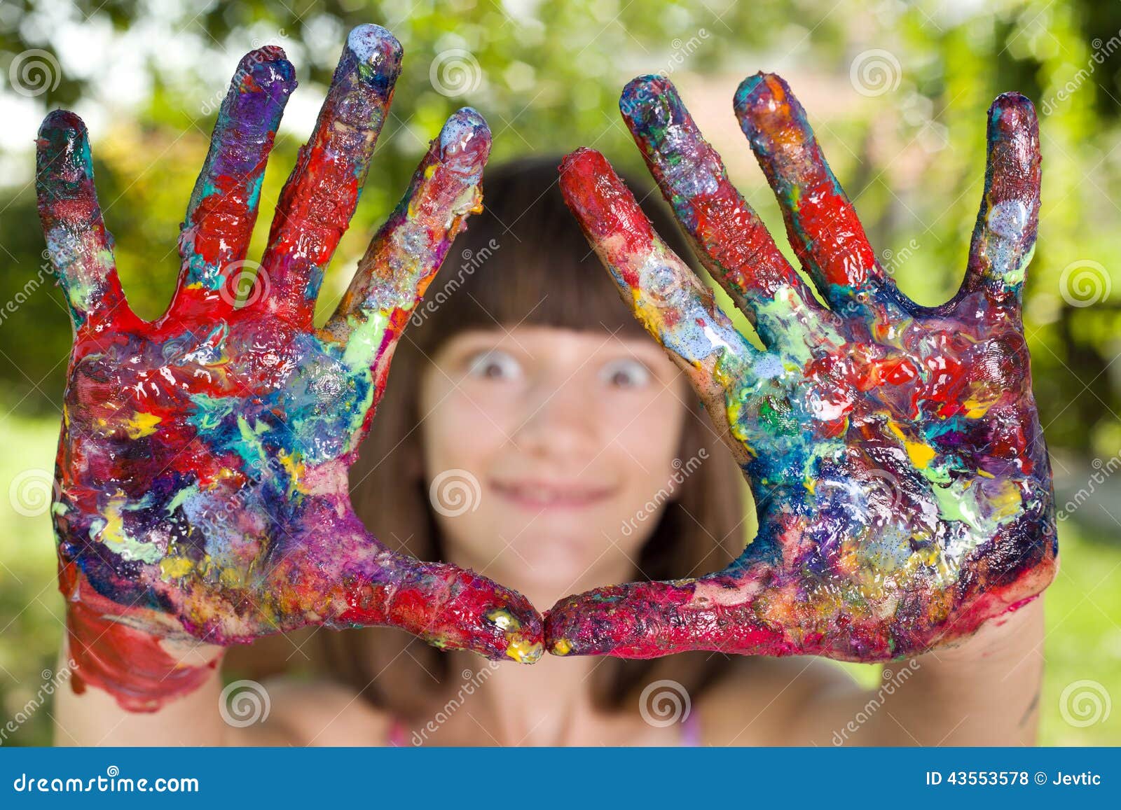 Girl with painted hands stock photo. Image of coloring - 43553578