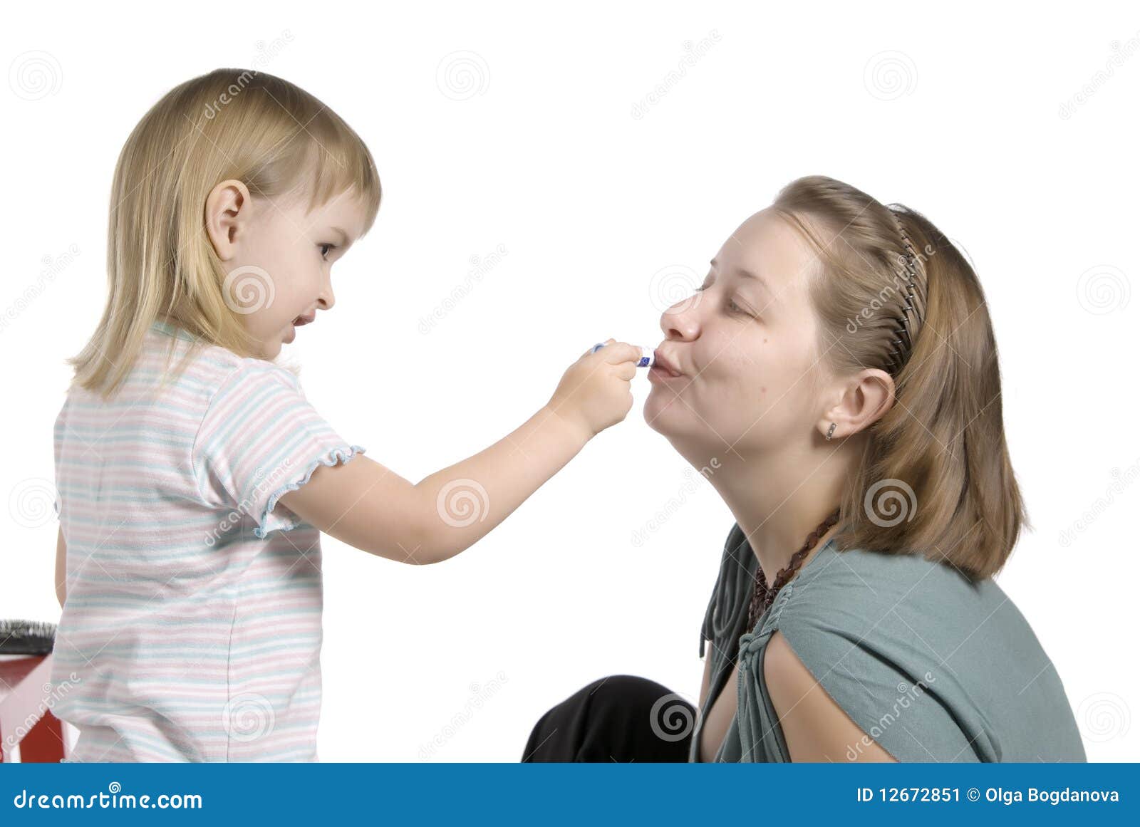 Girl paints lips to mum stock image. Image of fair, green - 12672851