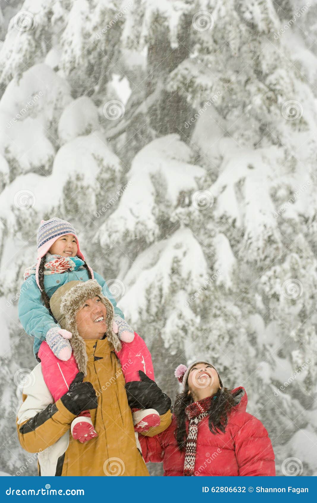 Girl and parents in snow stock photo. Image of looking - 62806632
