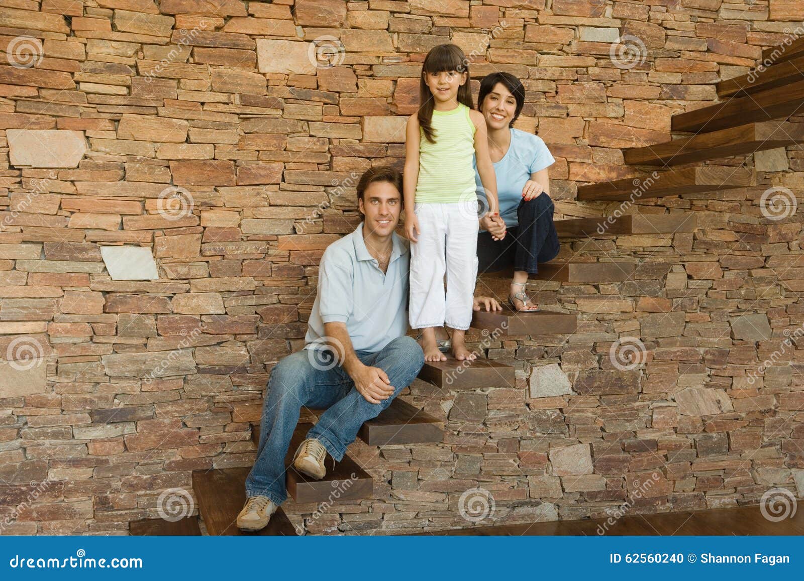 Girl and parents on stairs stock photo. Image of looking - 62560240