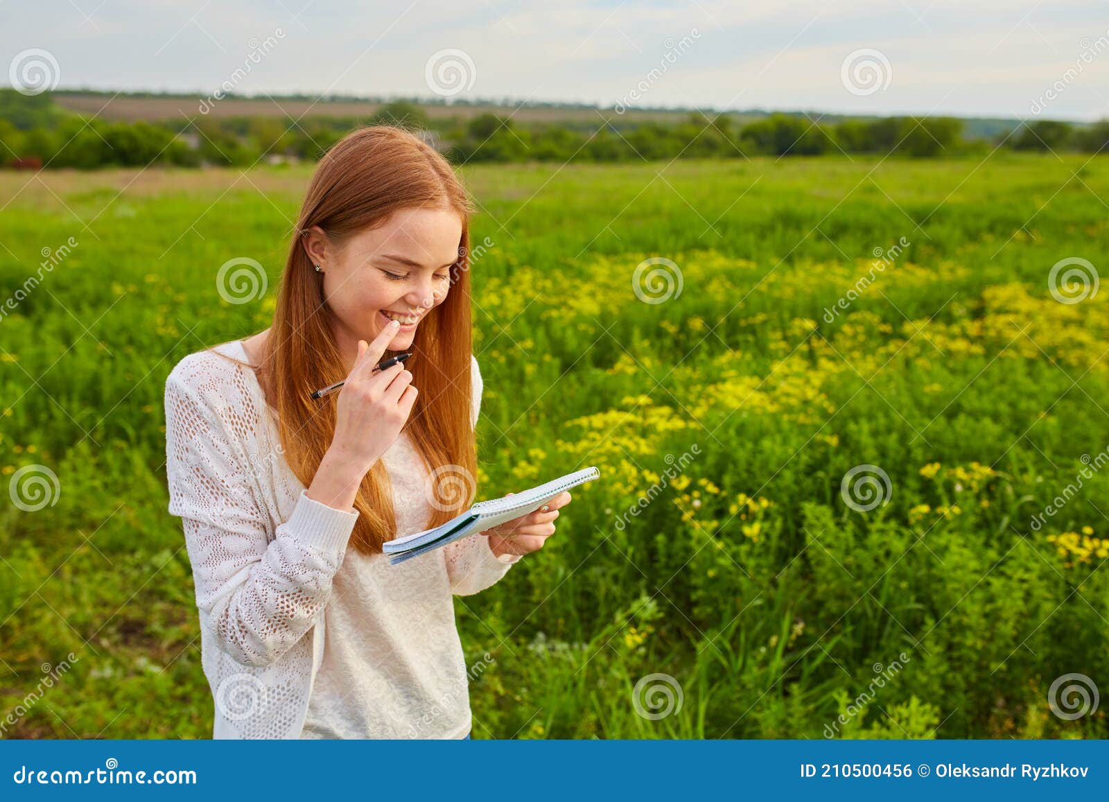 Girl with Pen Writing on Notebook on Grass Outside Stock Photo - Image ...