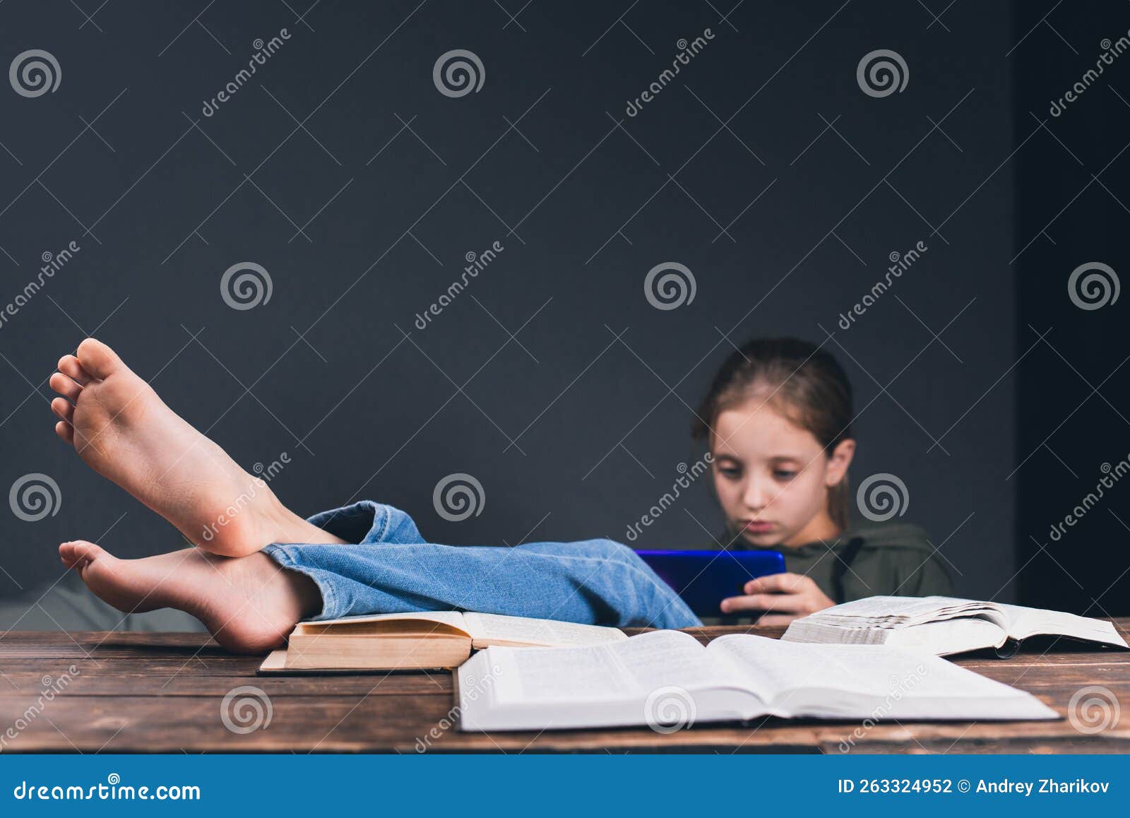 A Girl with a Phone in Her Hands. the Girl Plays on the Phone, Ignoring ...