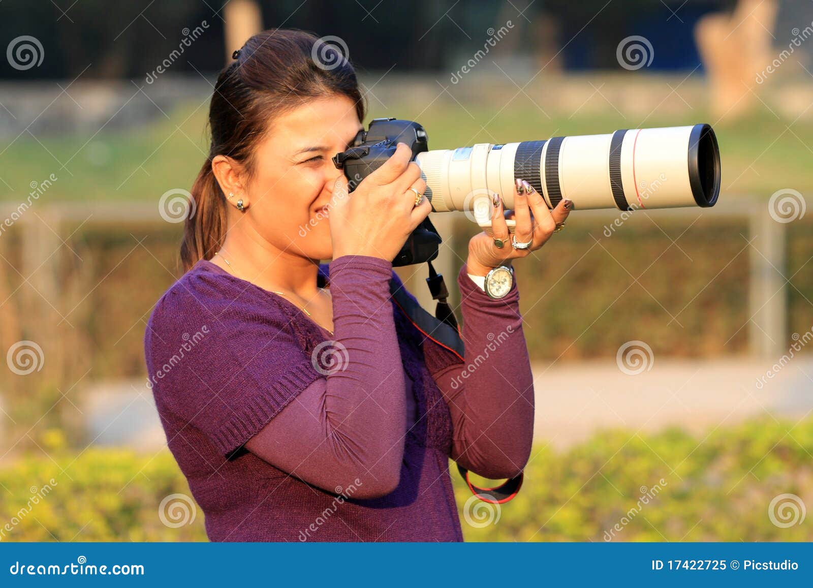 A Girl Photographer Uses A Smartphone And Sits On A Granite Para ...