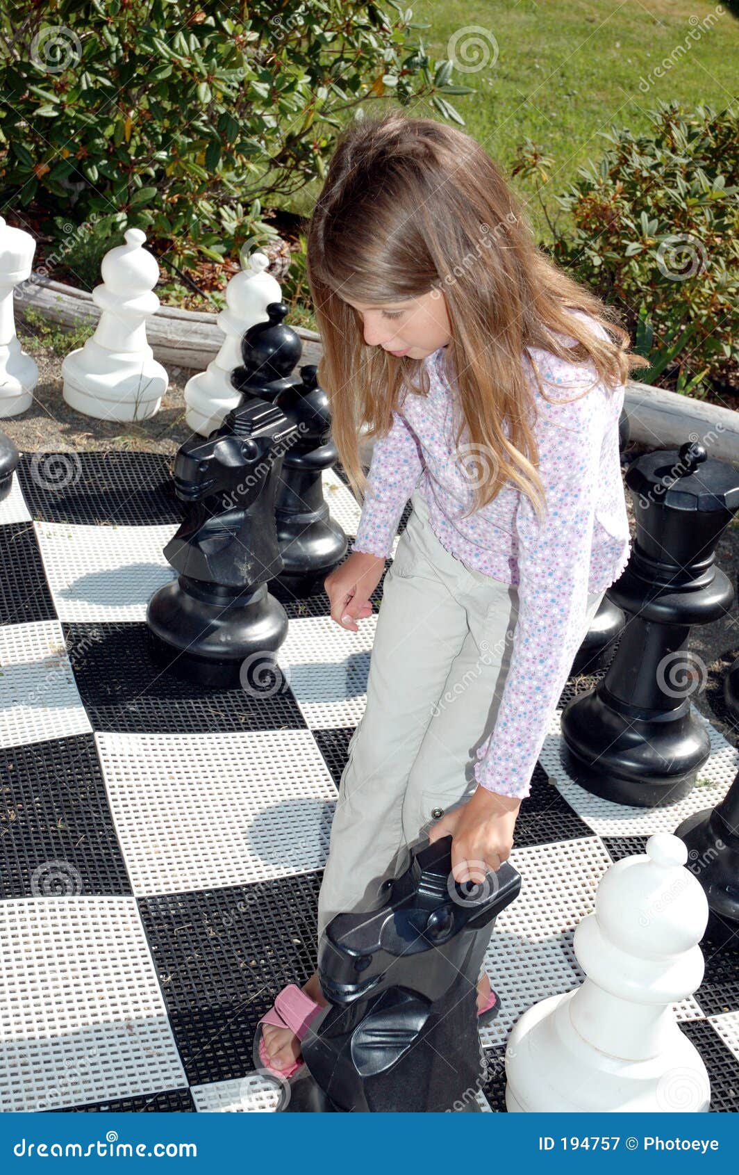 Girl playing big chess set stock image. Image of winner - 194757