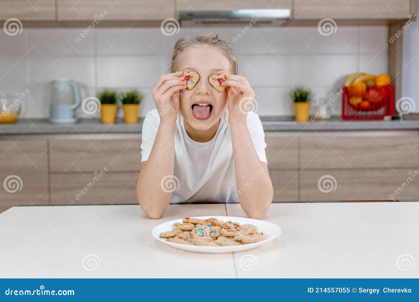 A Girl is Playing with Cookies in the Kitchen Stock Image - Image of ...