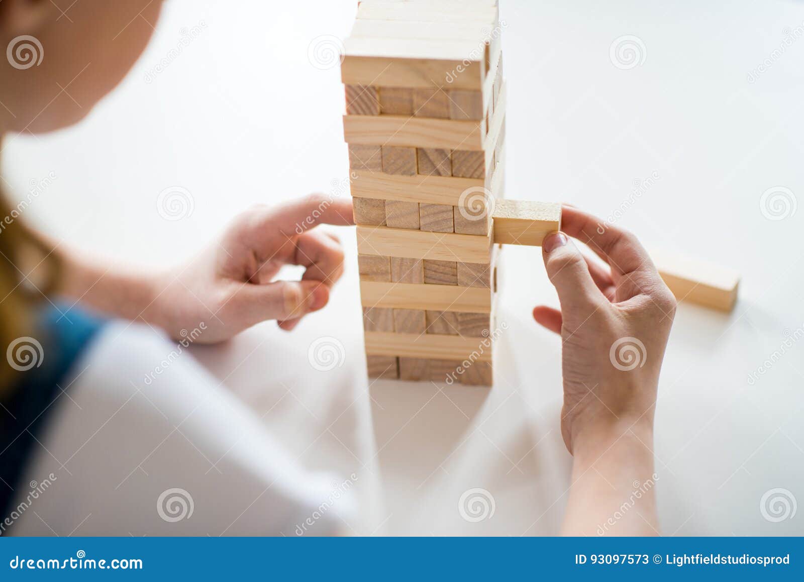 Girl Playing Jenga Game on White Table Stock Image - Image of partial ...