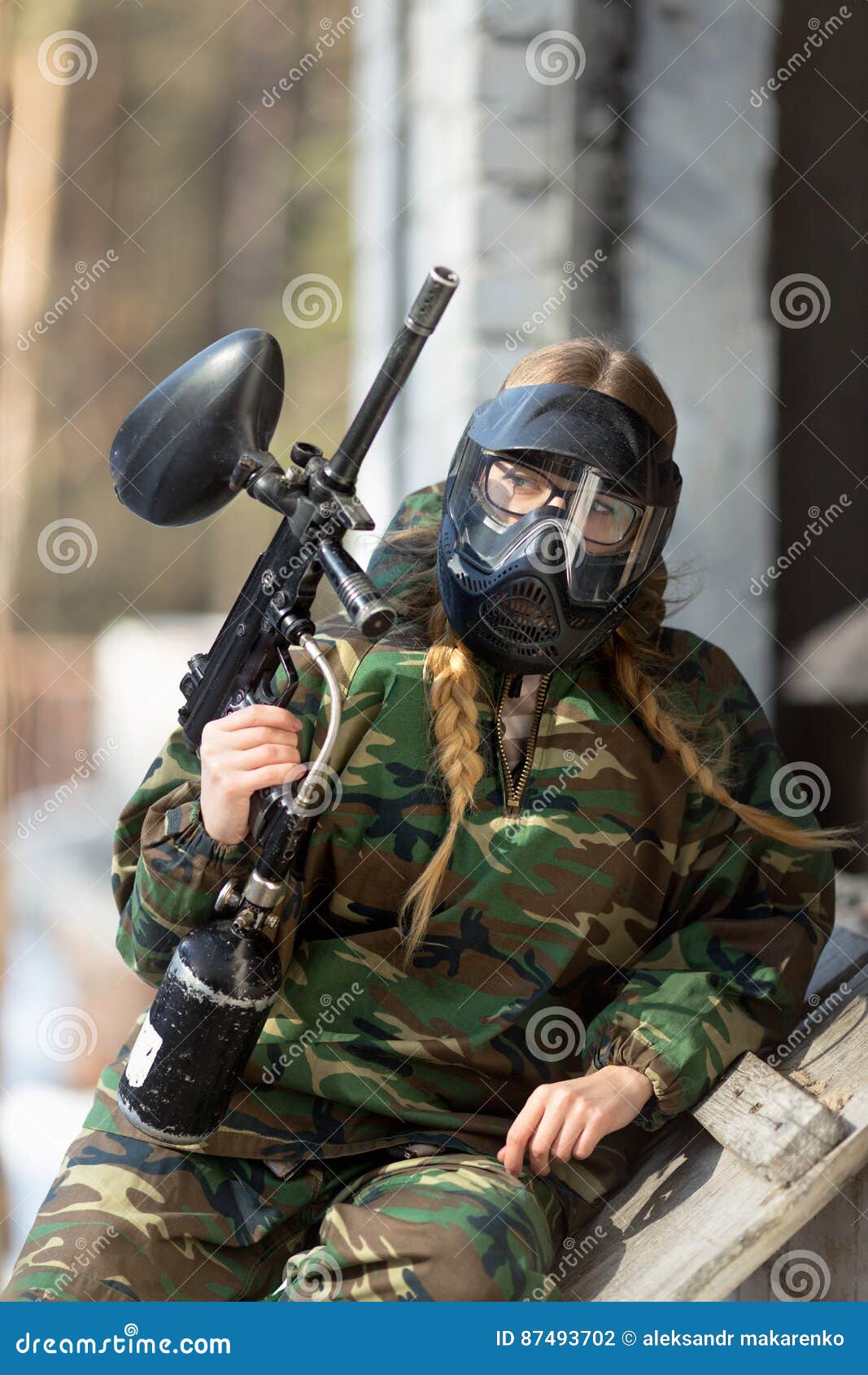 Girl Playing Paintball in Overalls with a Gun. Stock Photo - Image of ...