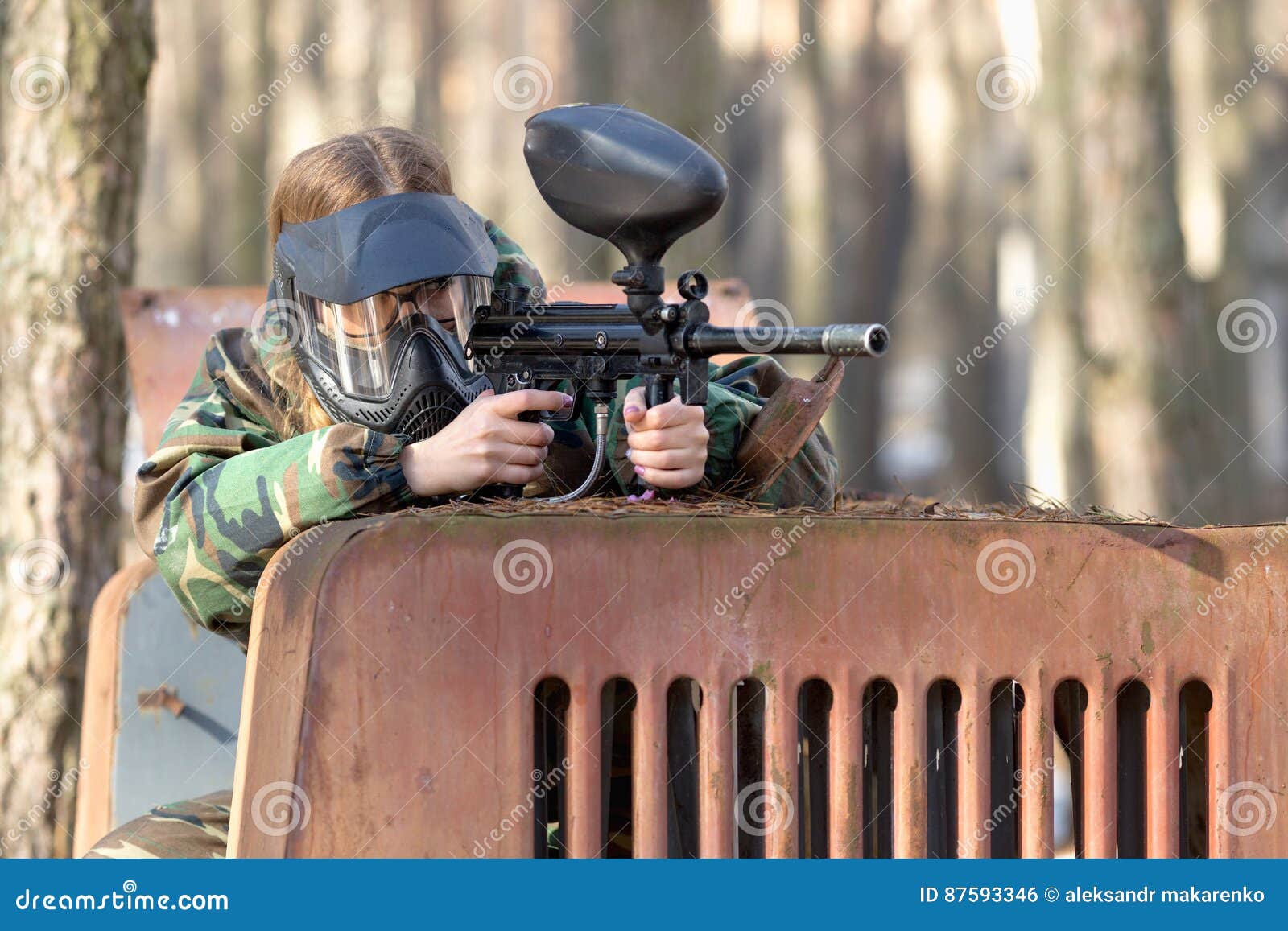 Girl Playing Paintball in Overalls with a Gun. Stock Photo - Image of ...