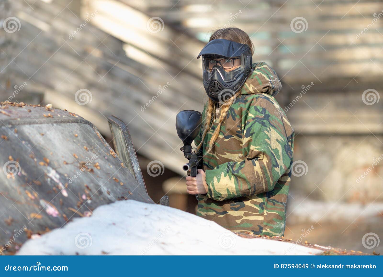 Girl Playing Paintball in Overalls with a Gun. Stock Image - Image of ...