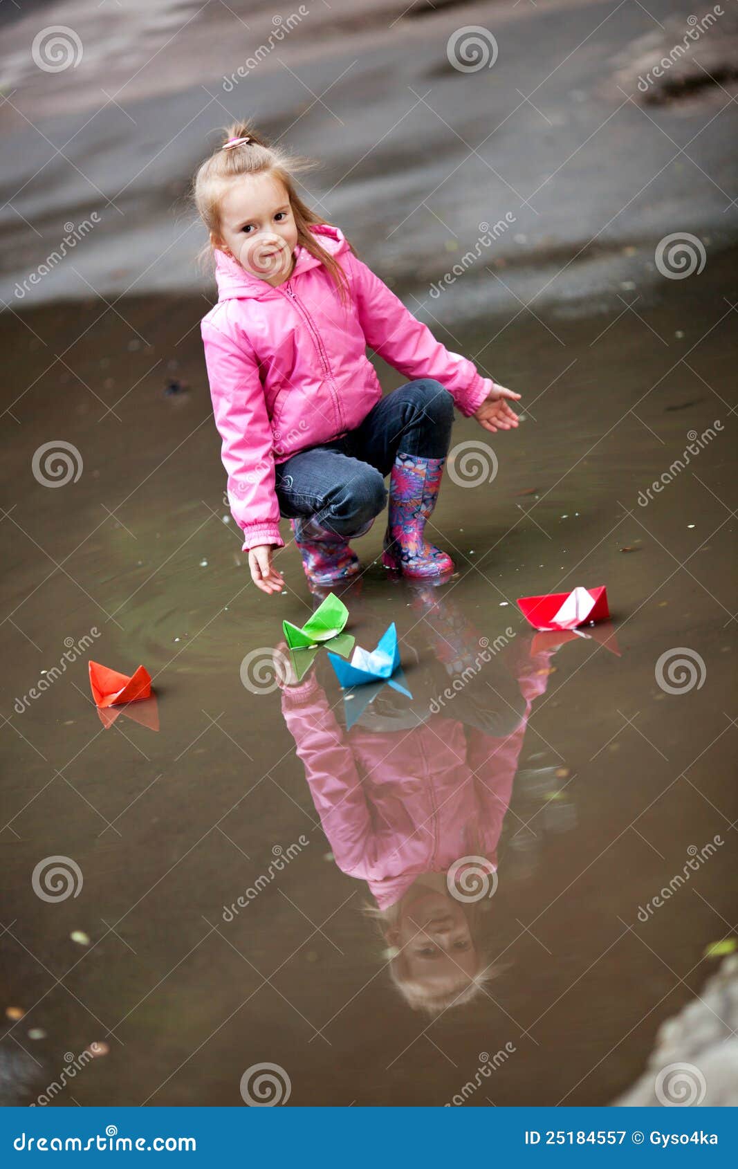 Girl playing in puddle stock image. Image of sailing - 25184557