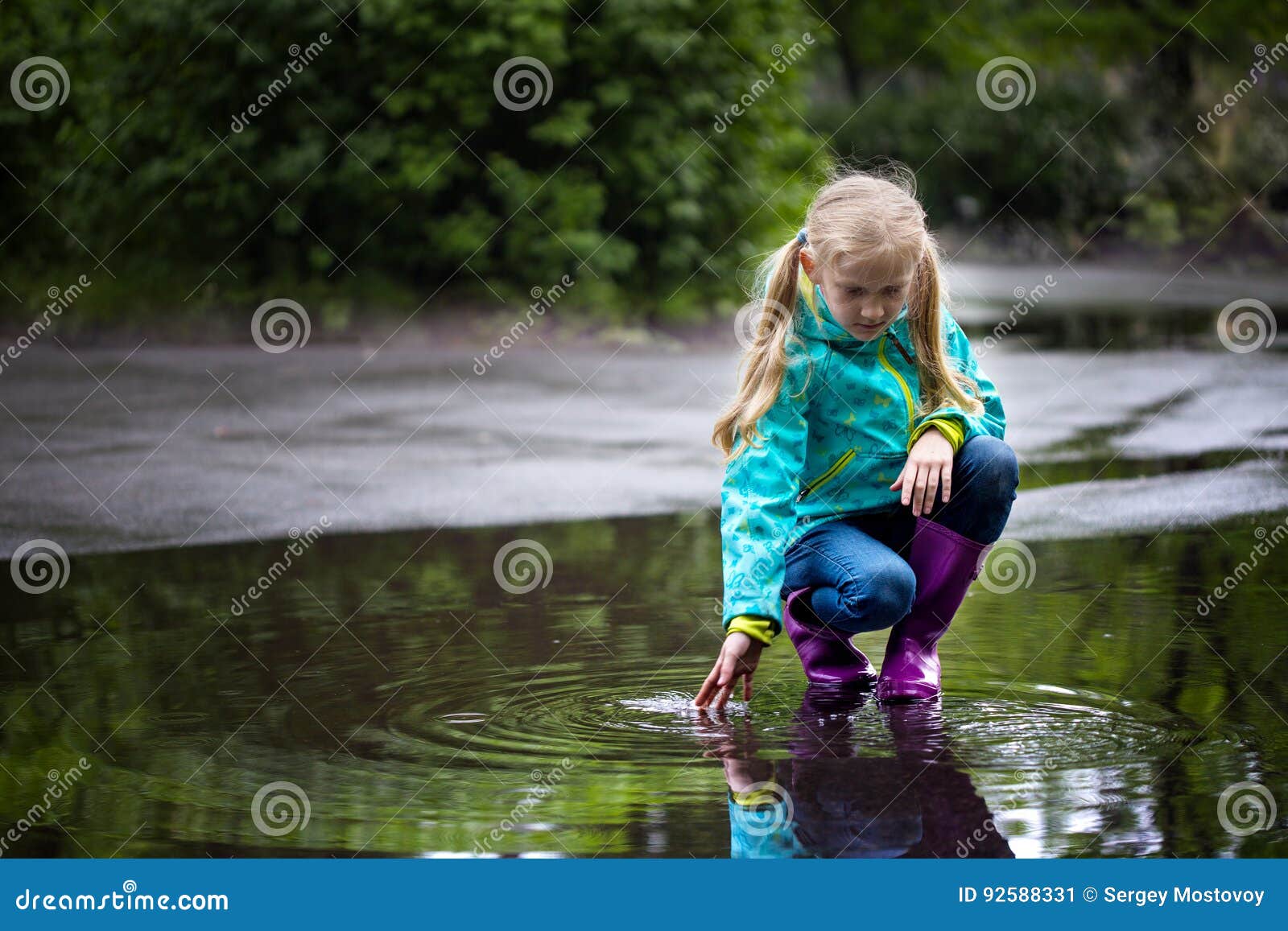 Girl playing in a puddle stock image. Image of happy - 92588331