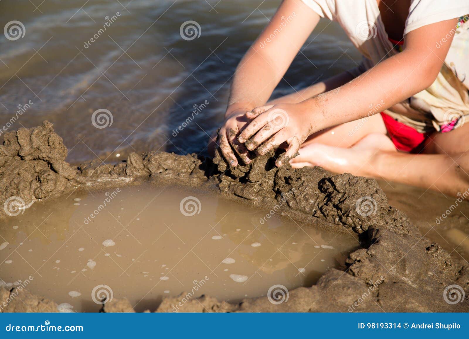 Girl Playing in the Sand on the Lake Stock Photo - Image of shell ...
