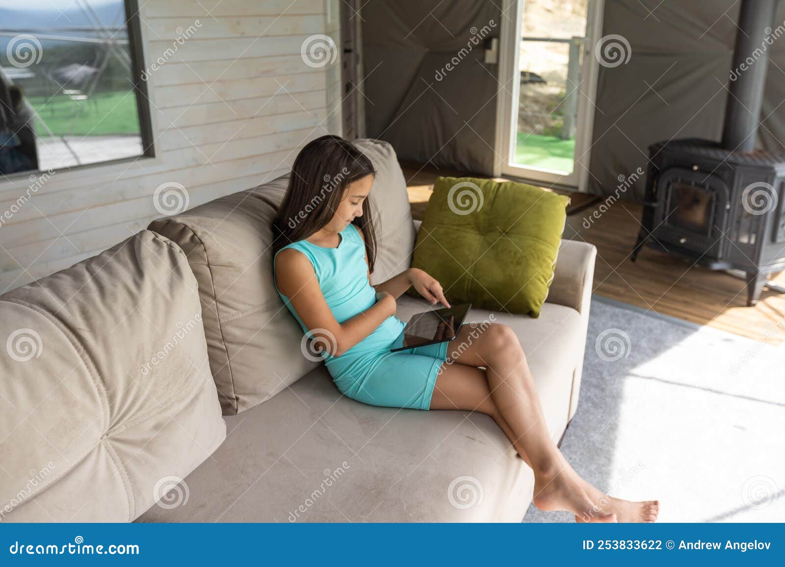Girl playing in the tablet stock photo. Image of home - 253833622