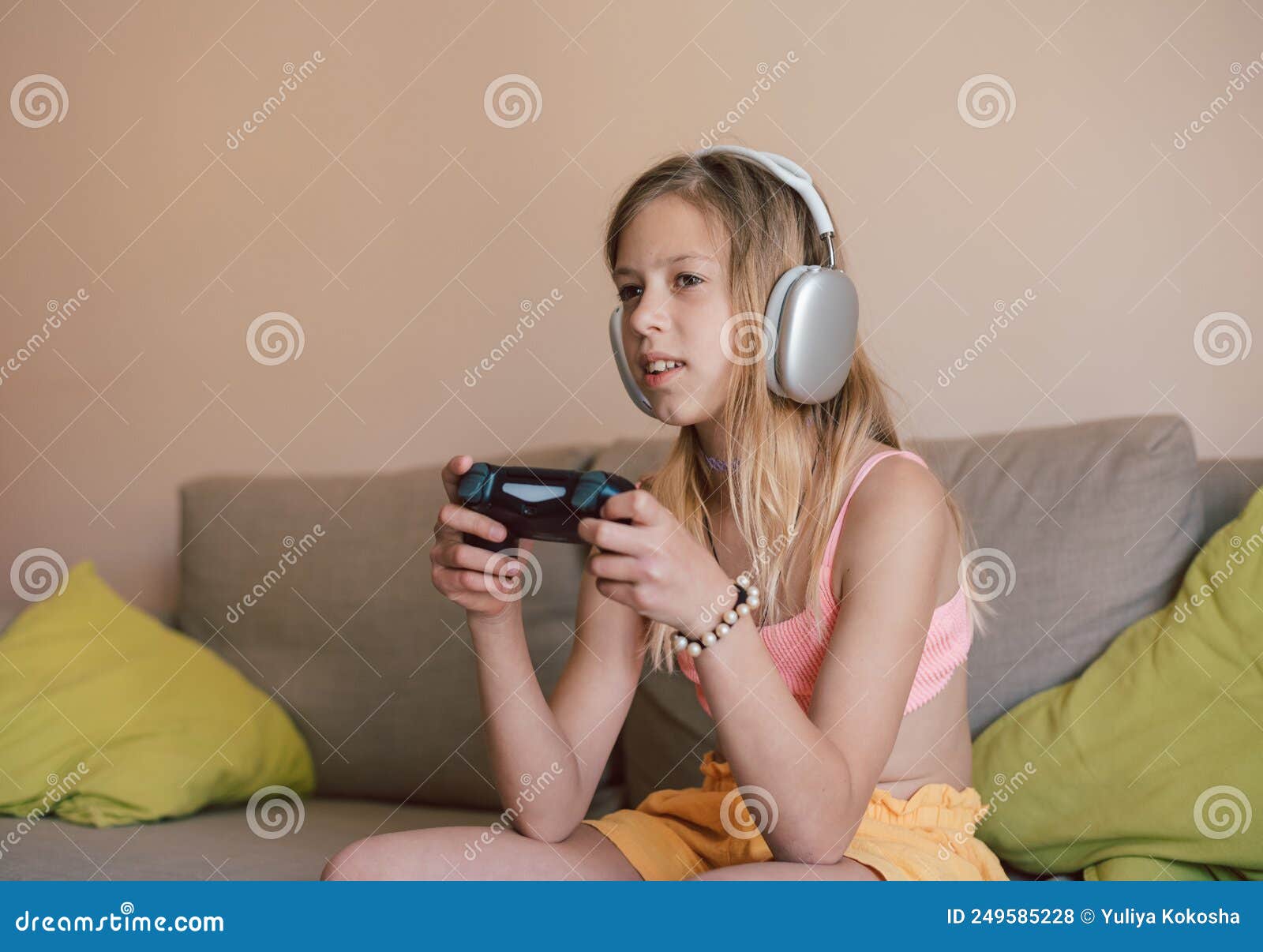 Girl playing video games stock photo. Image of couch - 249585228