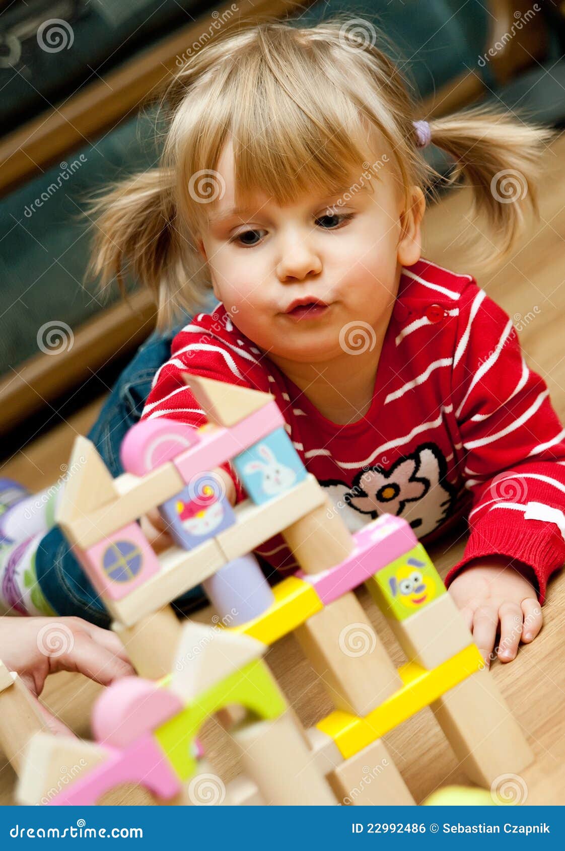 Girl Playing with Wood Blocks Stock Photo - Image of lying, floor: 22992486