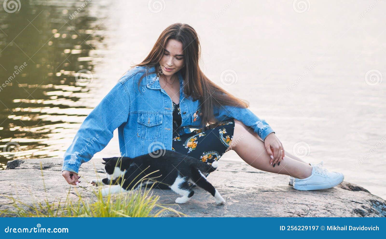 A Girl Plays with a Cat by the Lake. Stock Image - Image of person ...