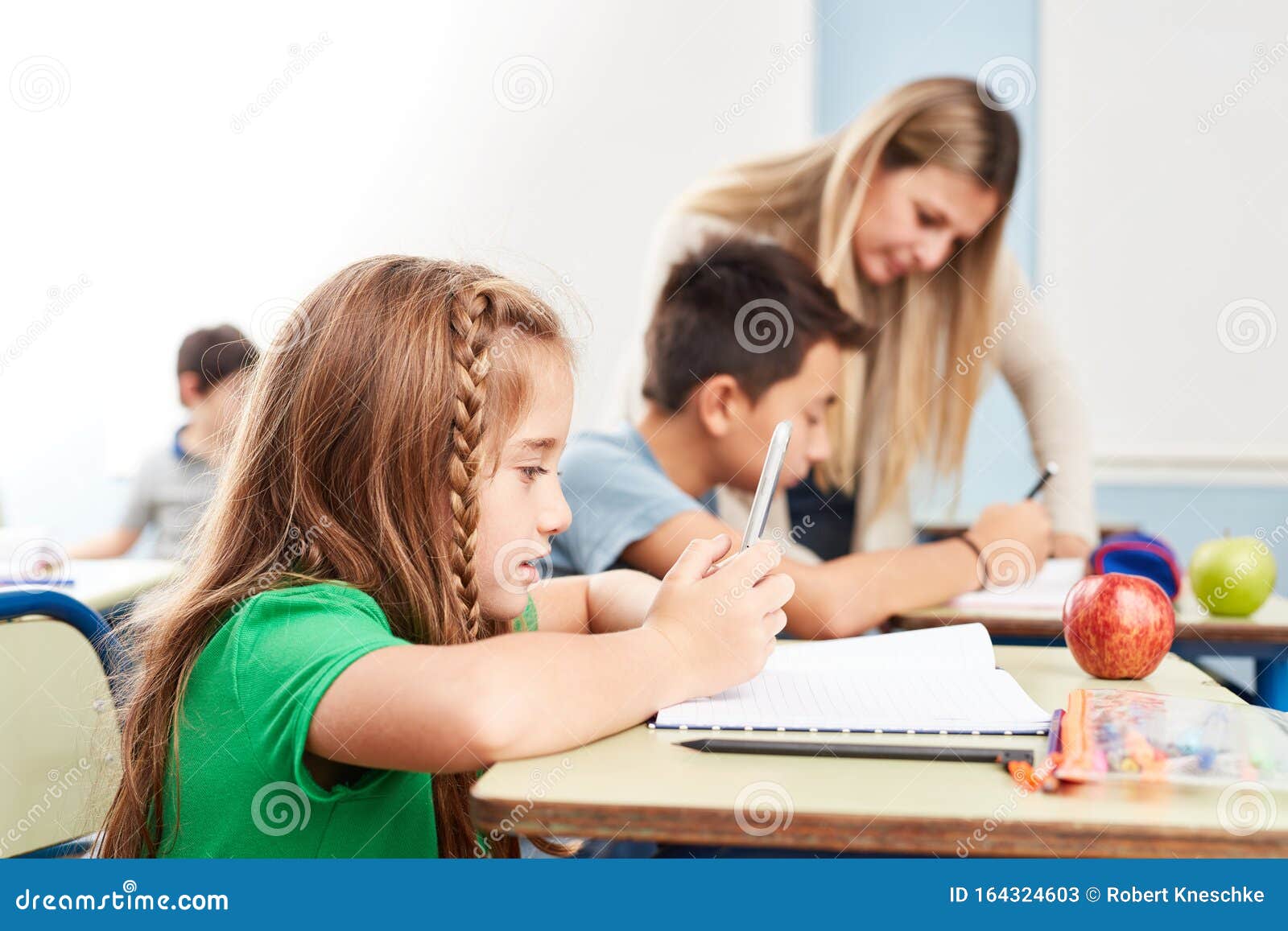 Girl Plays with Smartphone in the Classroom Stock Image - Image of ...