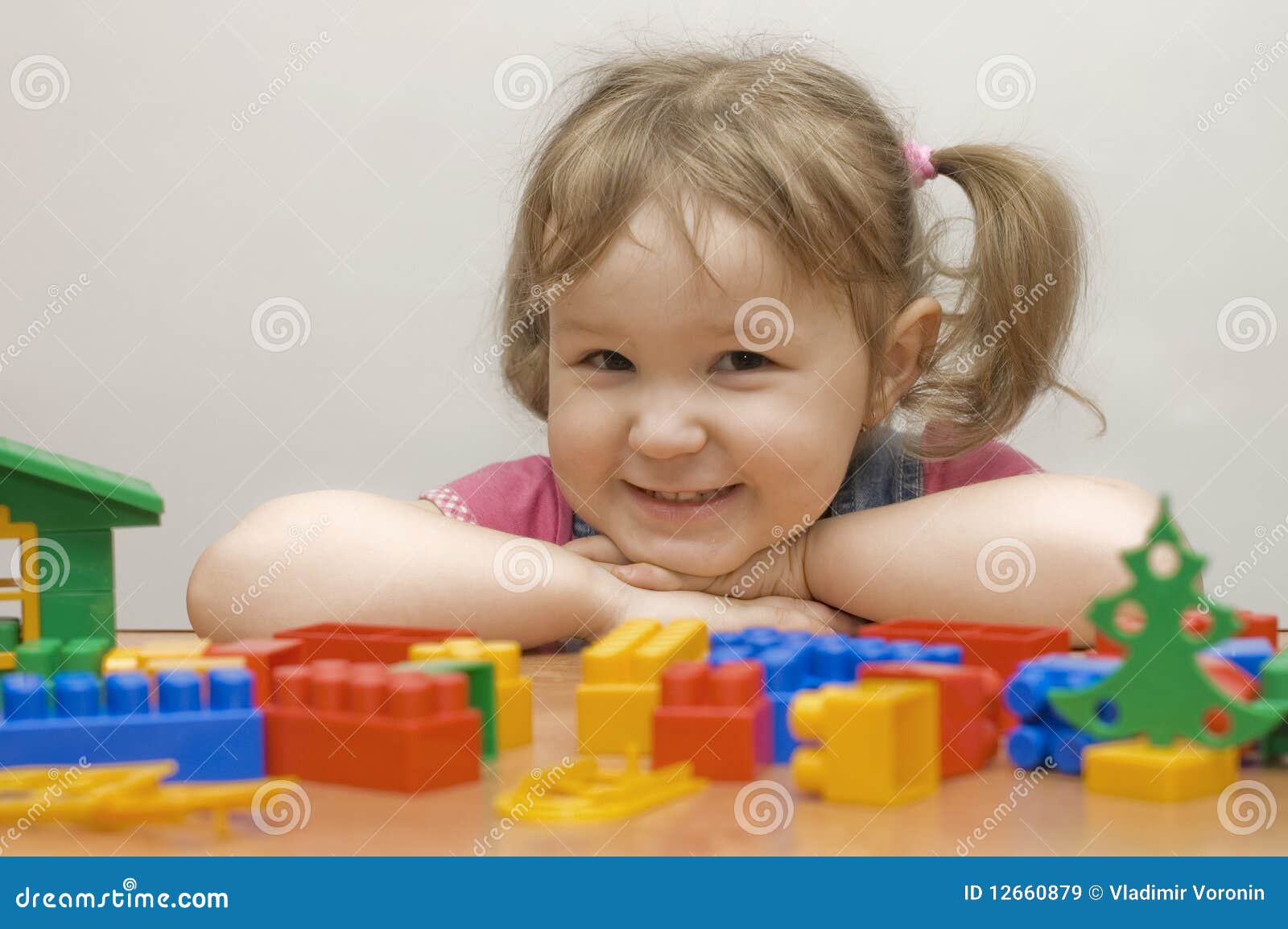 Girl plays with toy blocks stock image. Image of cube - 12660879