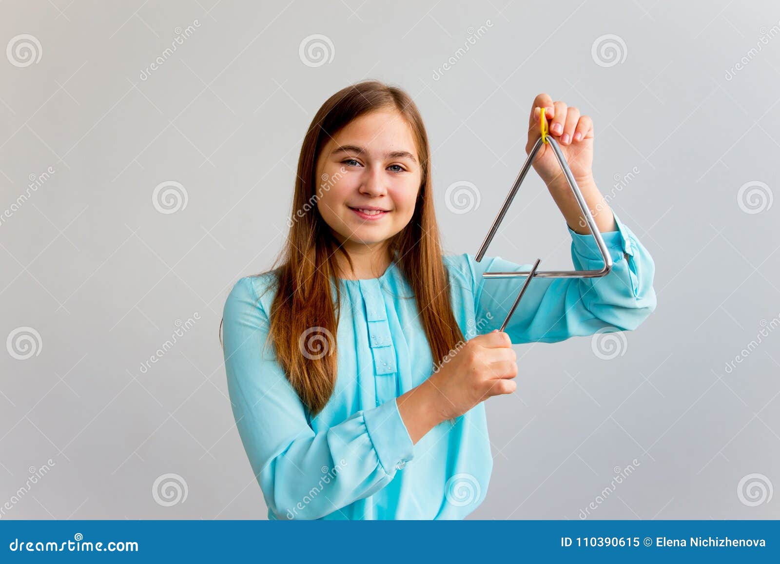 Girl plays a triangle stock image. Image of loud, hands - 110390615