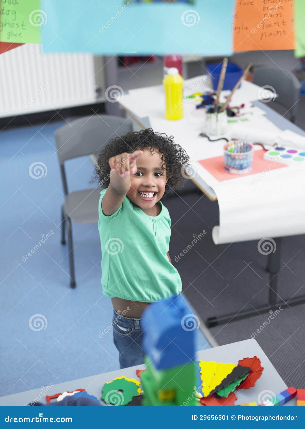 Girl Pointing in Classroom stock image. Image of education - 29656501