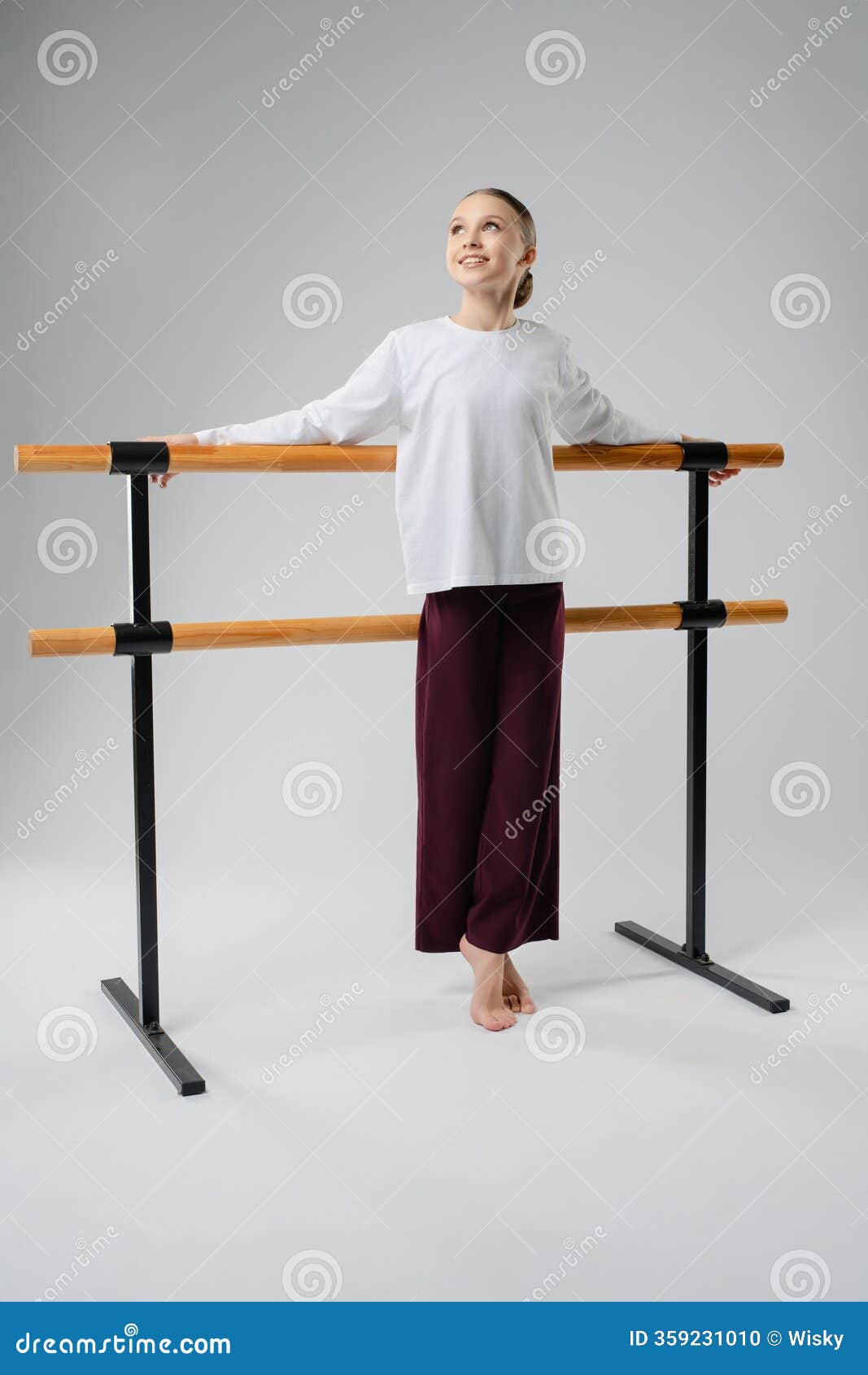 Girl Practicing Dance at the Ballet Bar in a Bright Studio Setting ...
