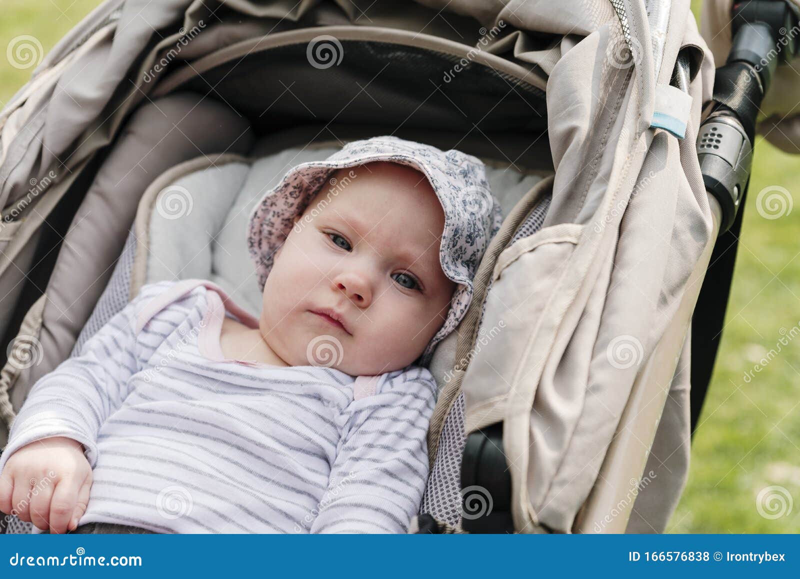 Girl in pram, sad face stock photo. Image of lifestyle - 166576838