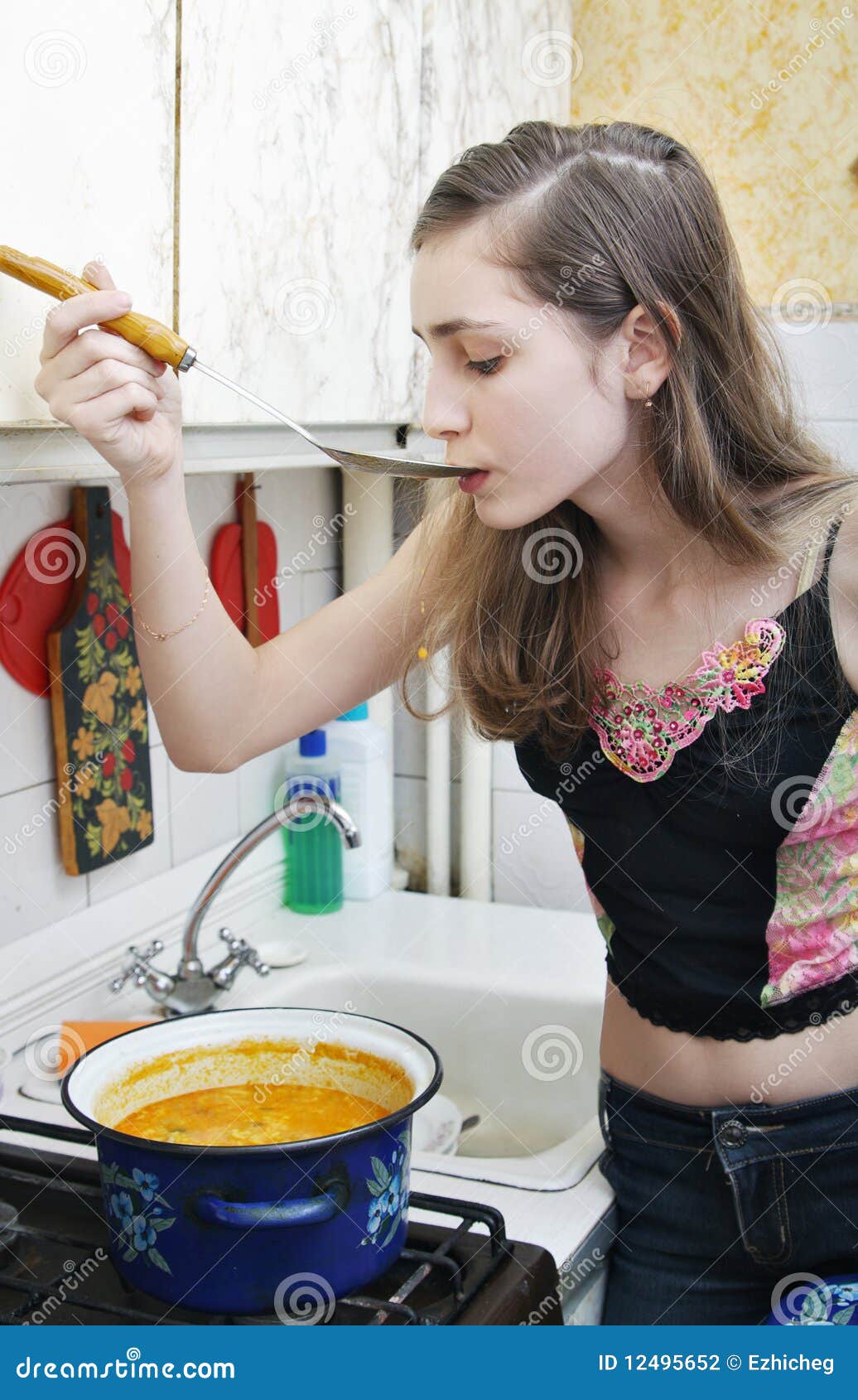 Girl prepares soup stock photo. Image of enjoyment, hair - 12495652