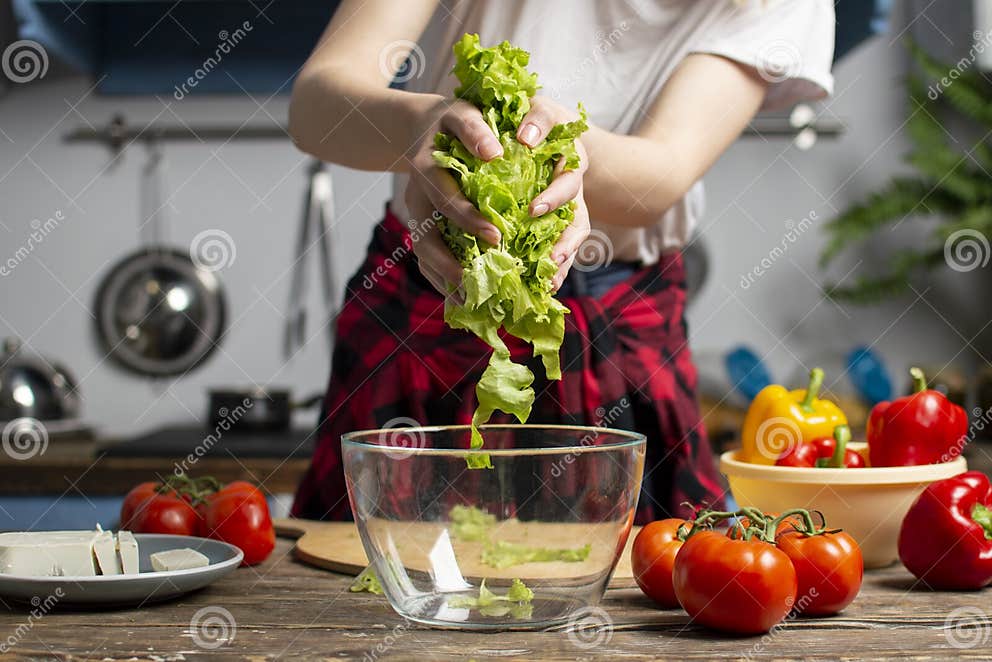 Girl Prepares A Vegetarian Salad She Adds Sliced Greens To An Empty