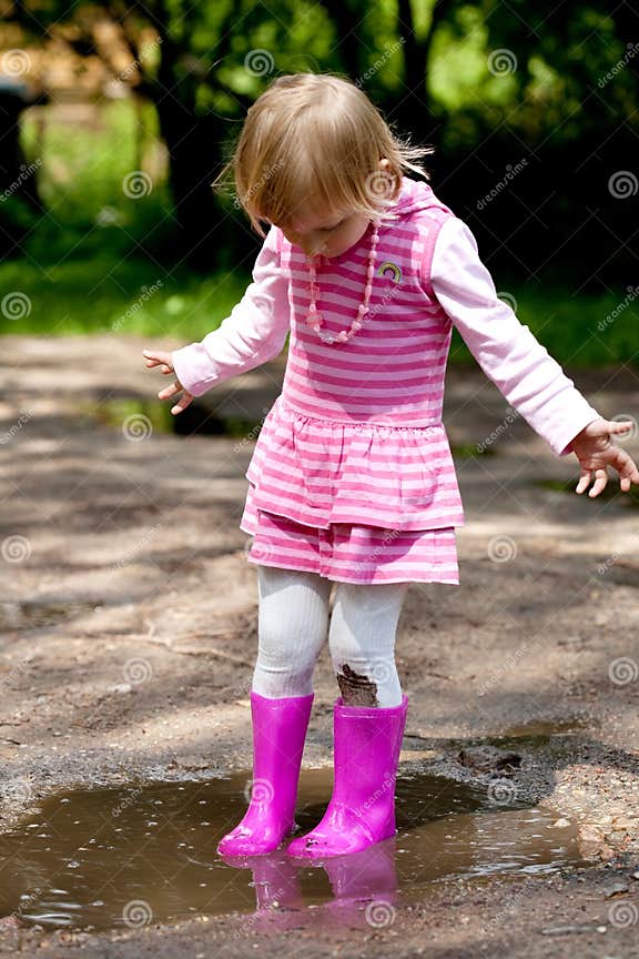 Girl in a puddle stock image. Image of child, cute, concern - 11965331