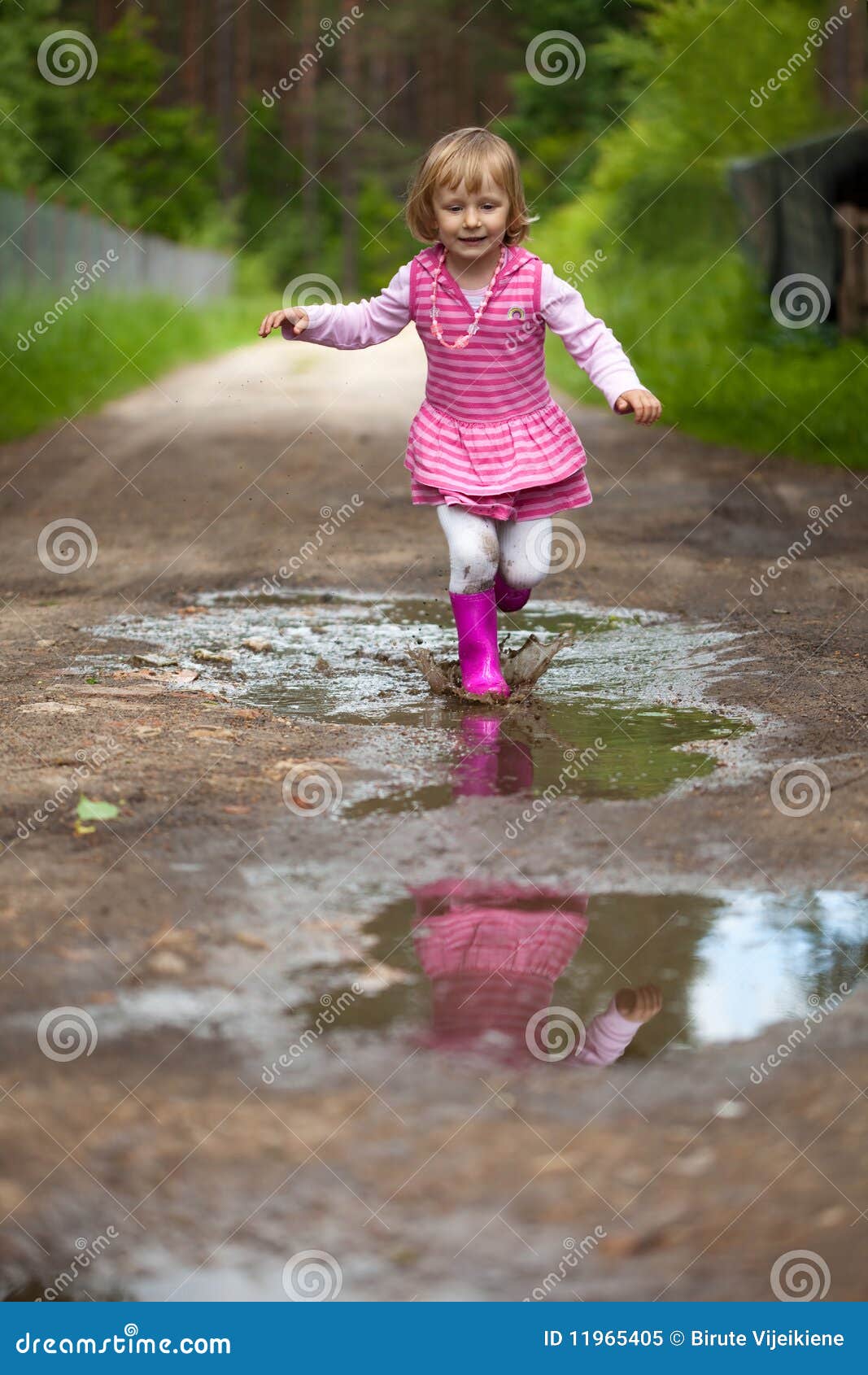 Girl in a puddle stock image. Image of puddle, green - 11965405