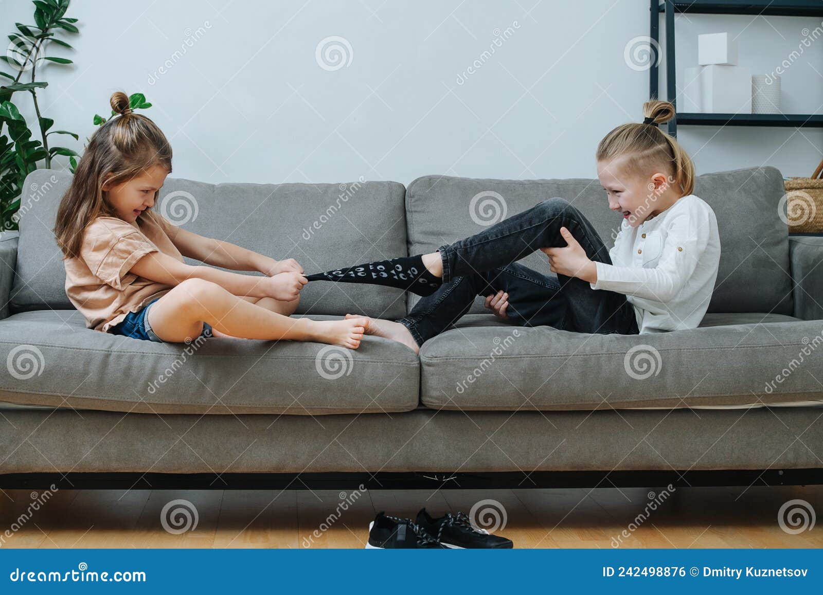 Girl Pulling Off Sock of a Boy, they are Preparing for a Tickling ...