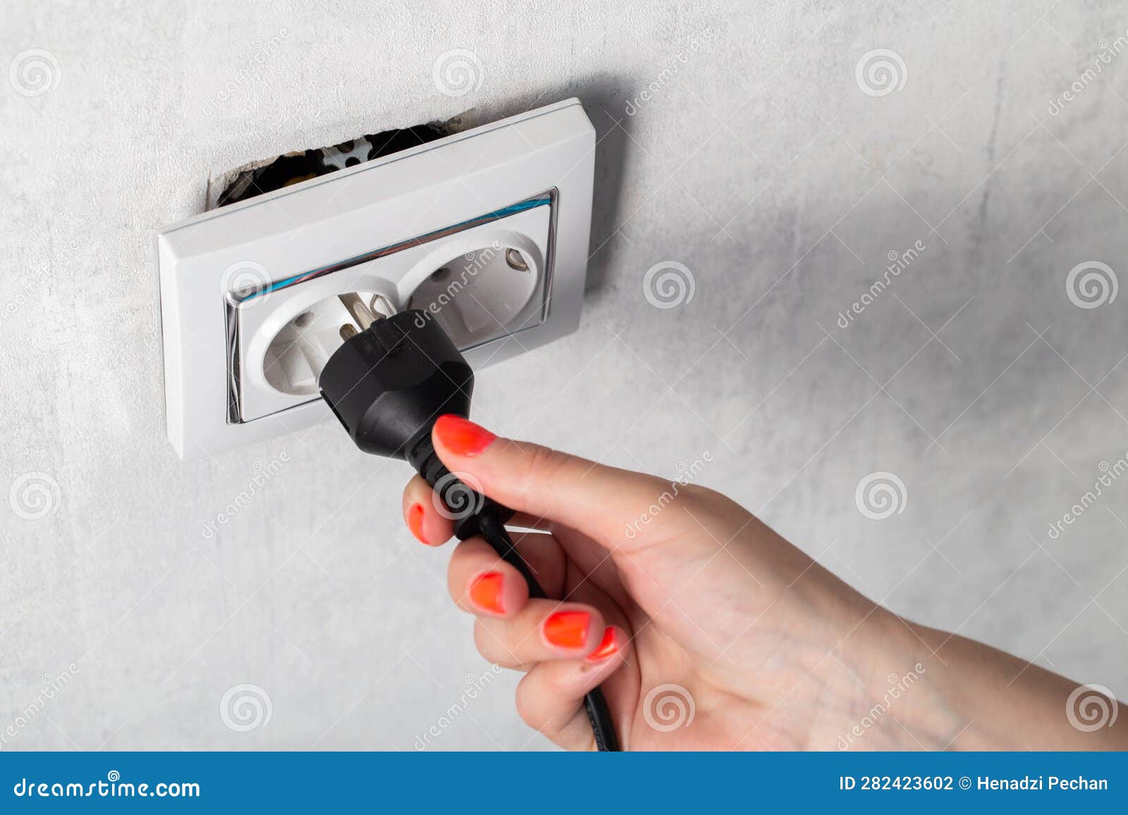 The Girl Puts the Electric Plug into a Broken Socket. Risk of Electric ...